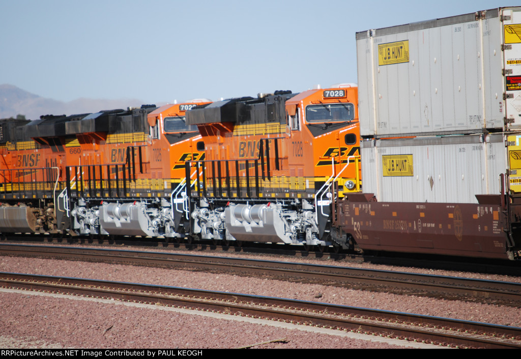 BNSF 7028 and BNSF 7026 start to slow down for a crewchange and continue east as #3 and #4 units ...